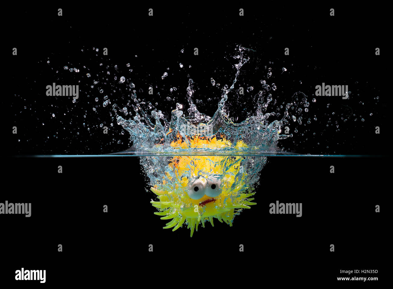Toy fish splash into water Stock Photo - Alamy