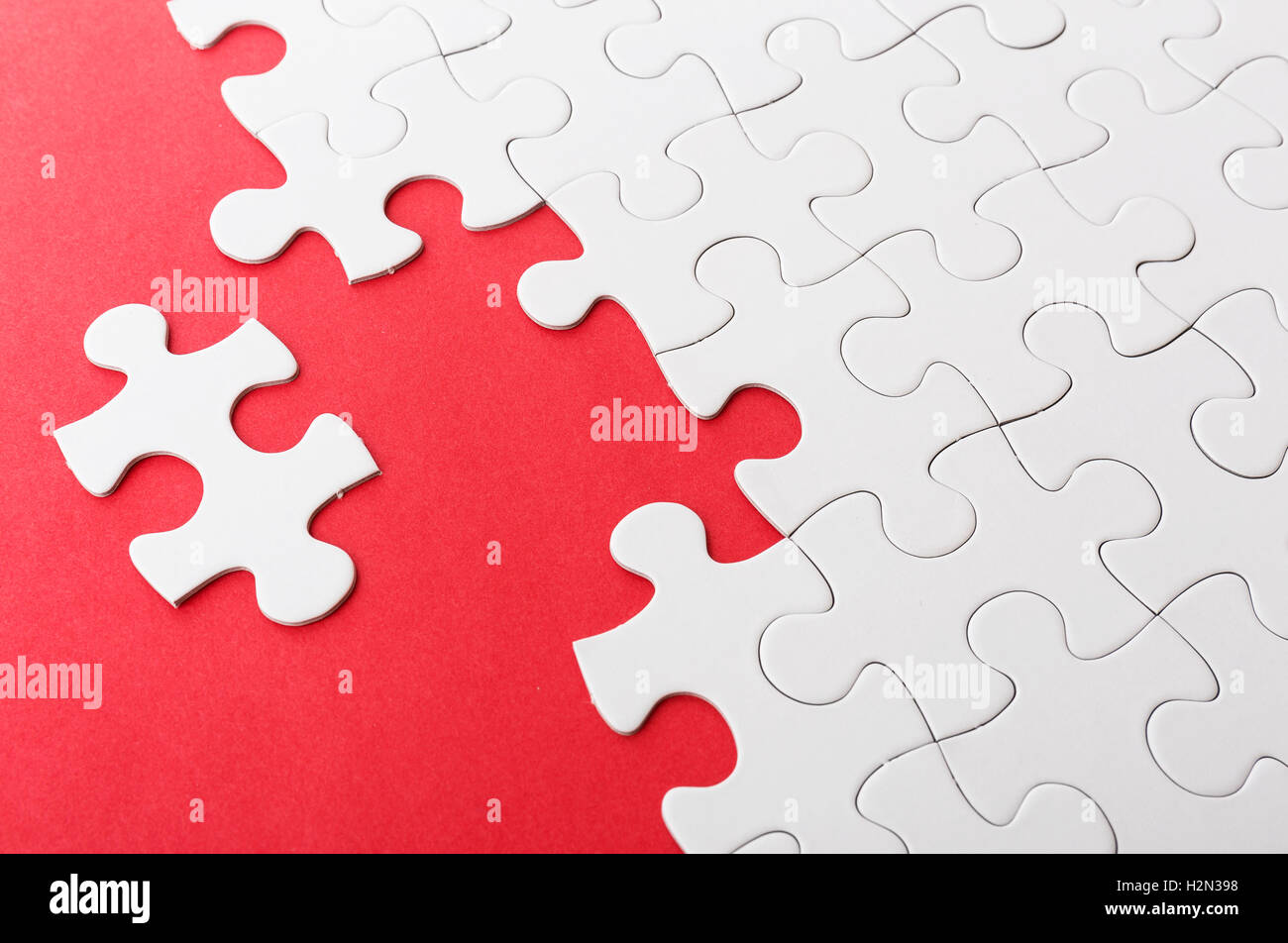 Incomplete puzzle with missing piece over red background Stock Photo ...