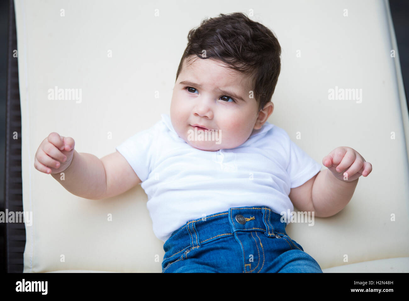 Cute little baby looking away Stock Photo - Alamy