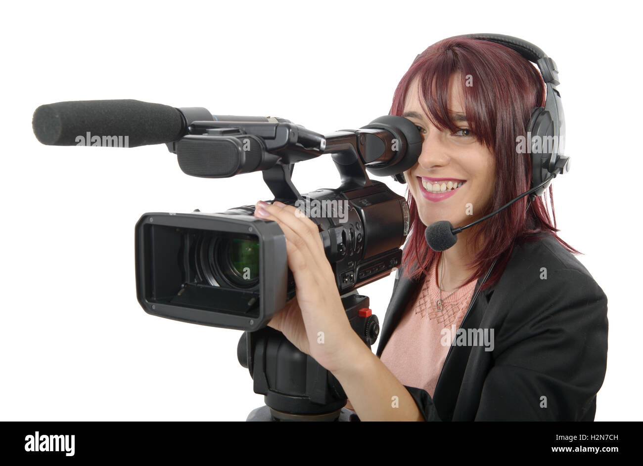a beautiful young woman with a professional video camera and headphone ...