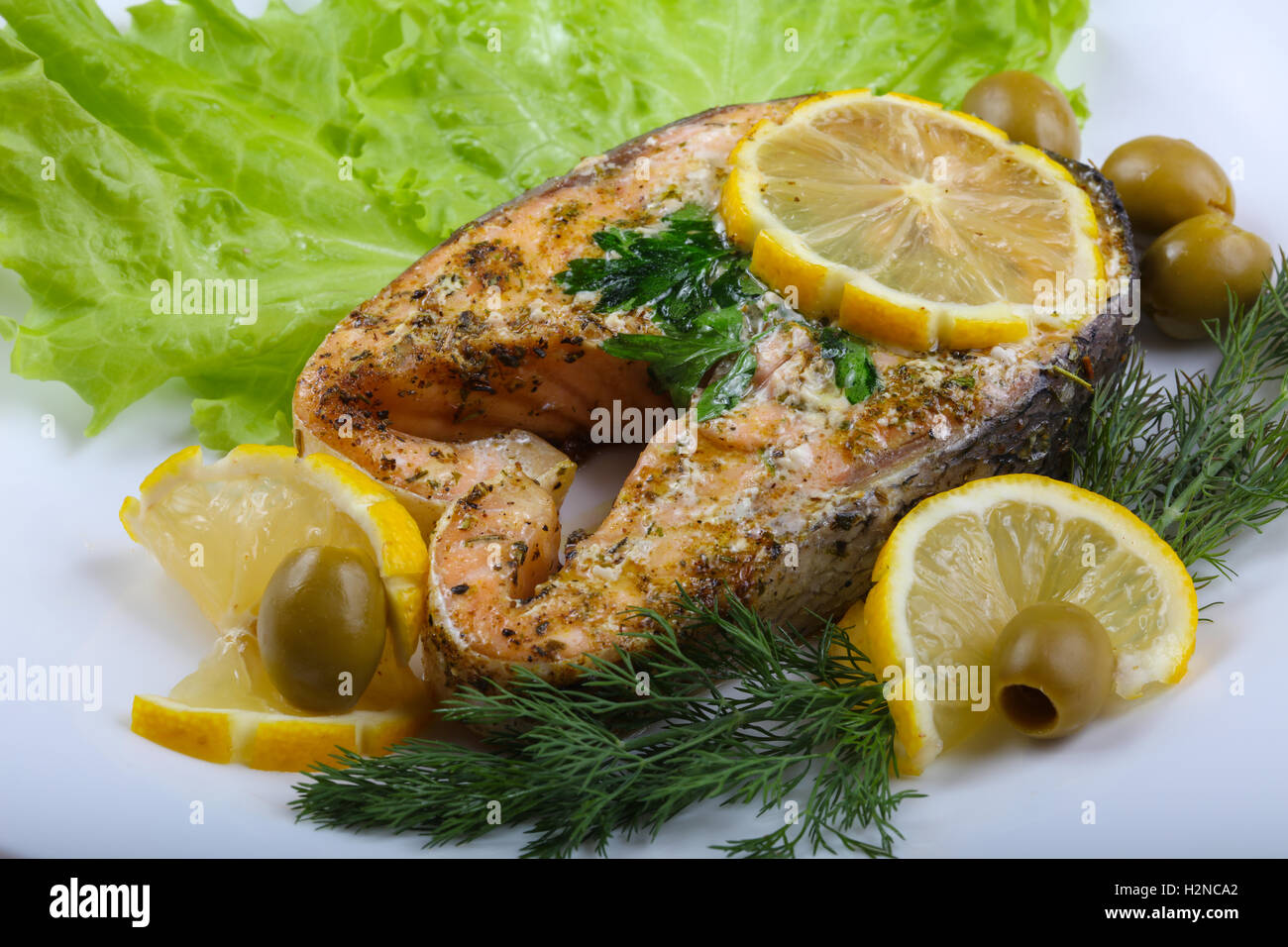 Baked salmon steak with lemon and olives Stock Photo - Alamy