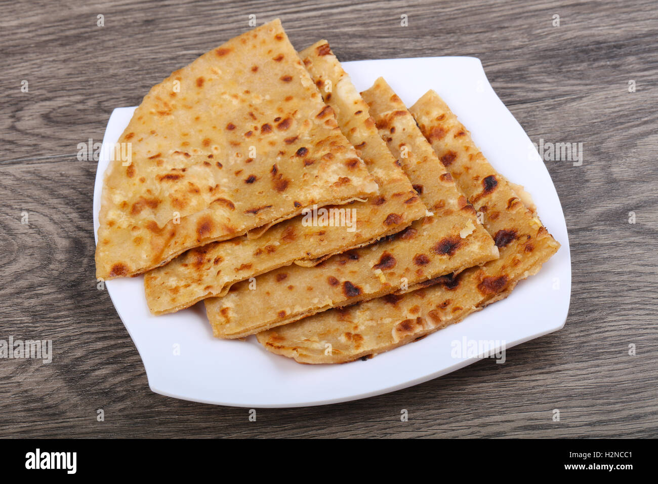 Indian bread roti on the plate in wood background Stock Photo - Alamy