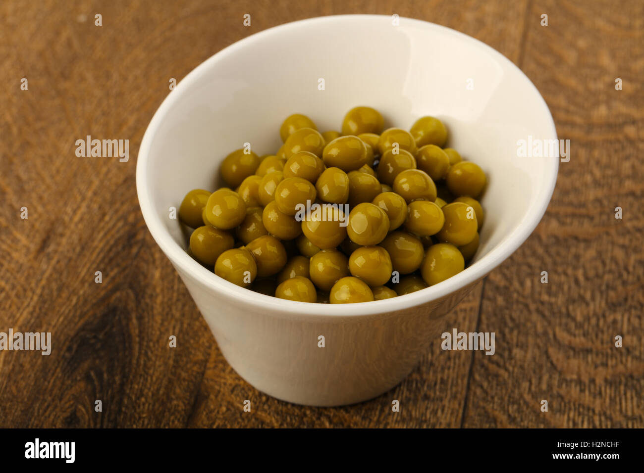 Pickled green pea on the wood background Stock Photo - Alamy