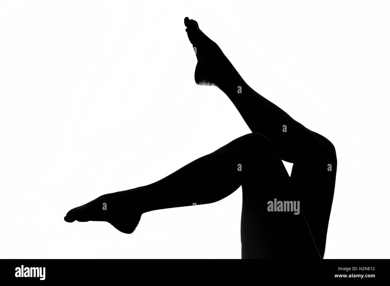 Beautiful woman legs in black and white. Backlight studio photo Stock ...
