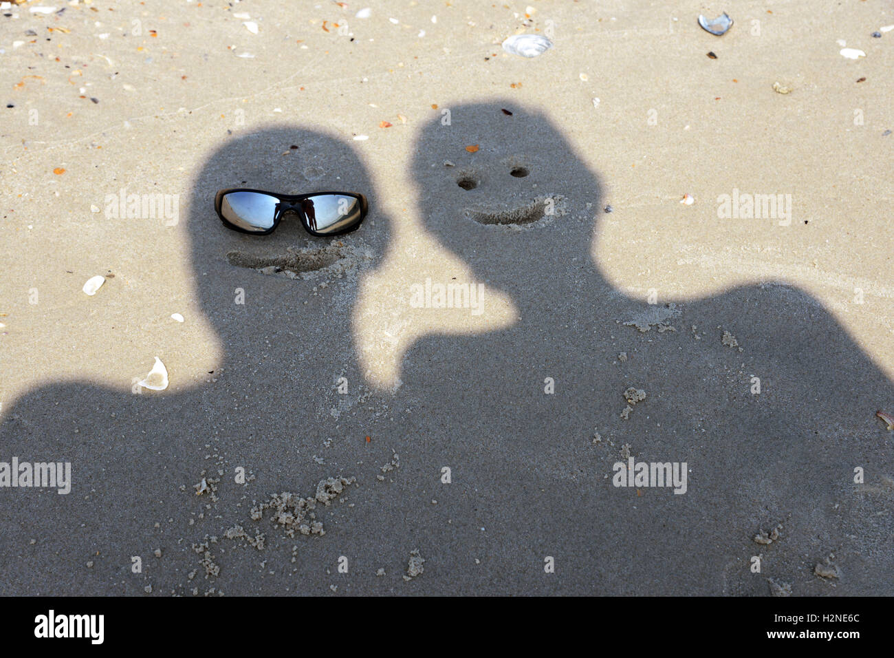 two smiling shadow on the beach Stock Photo - Alamy