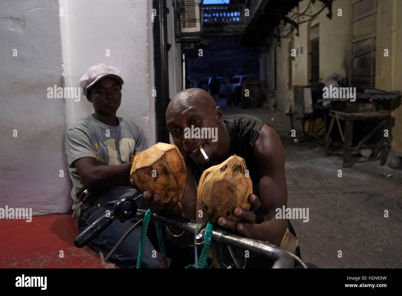 A man offers coconuts in Stone Town also known as Mji Mkongwe in the ...
