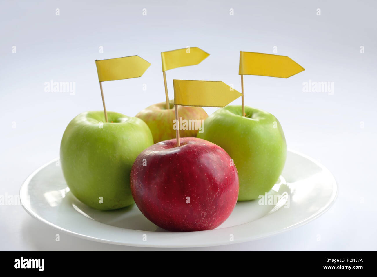 four apples with label on a plate Stock Photo - Alamy