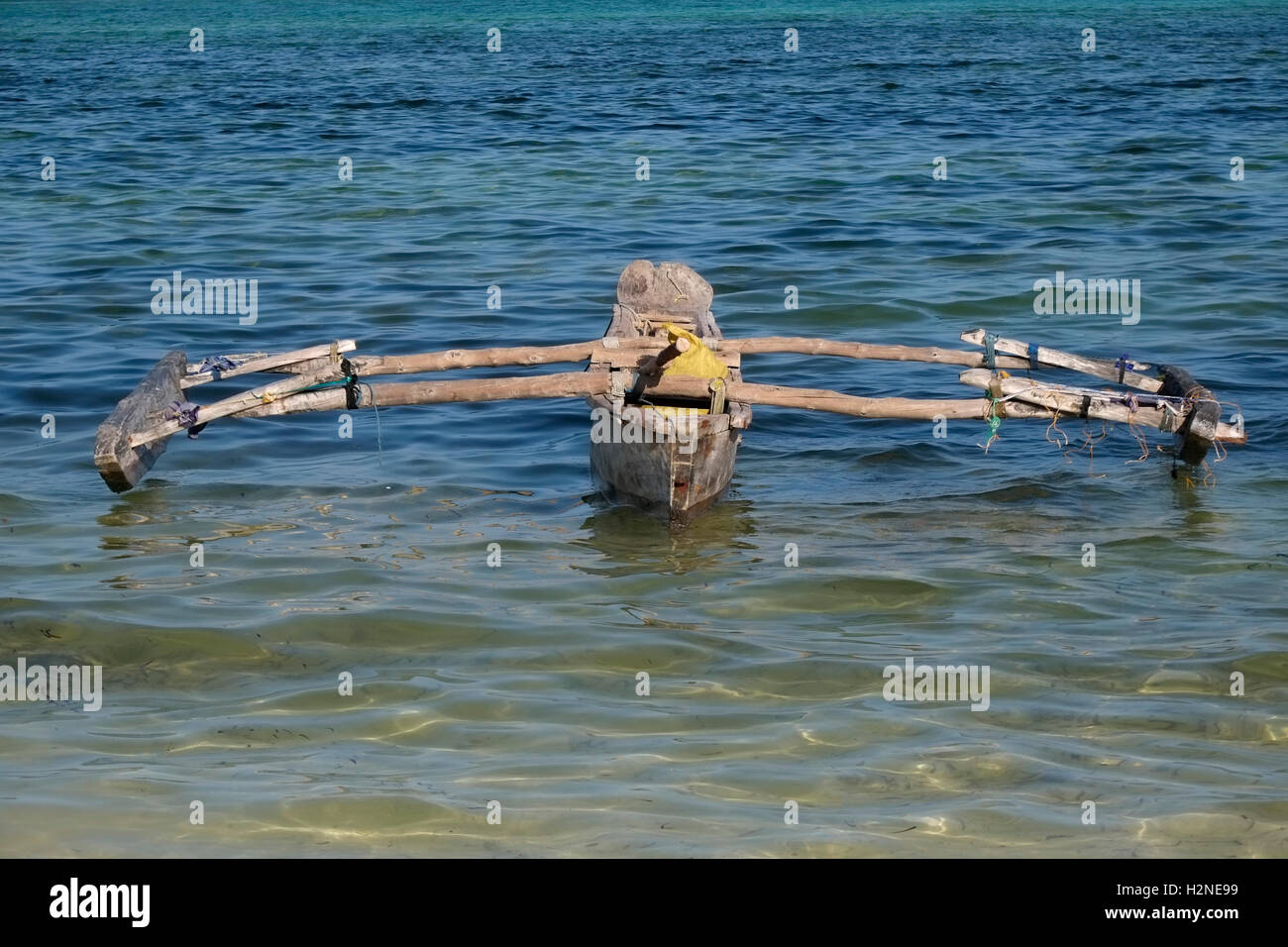 A Ngalawa or Ungalawa traditional, double-outrigger canoe used as a ...