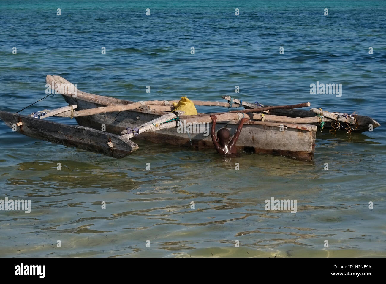 A Ngalawa or Ungalawa traditional, double-outrigger canoe used as a ...