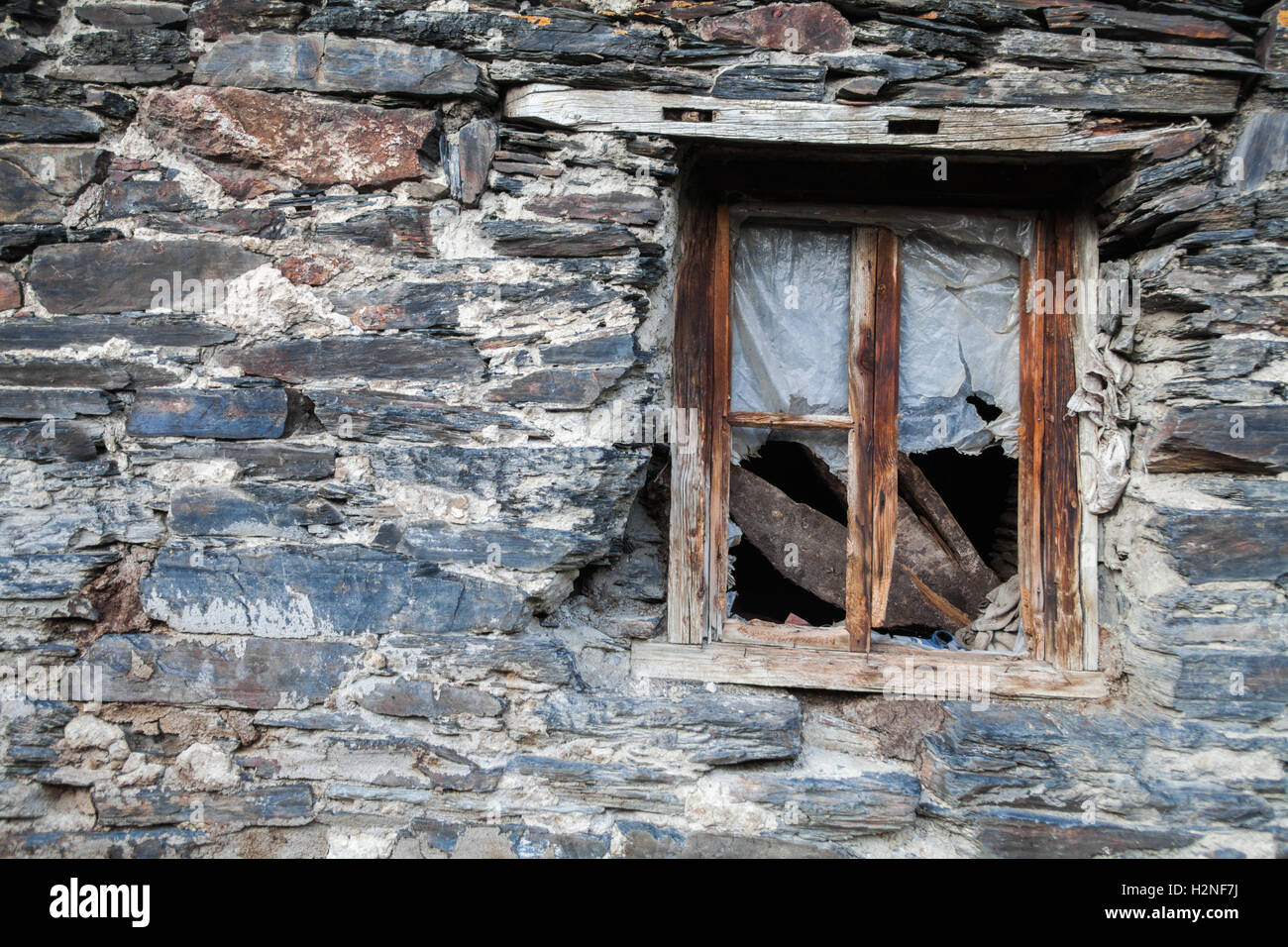 Color image of a broken window on a stone wall Stock Photo - Alamy