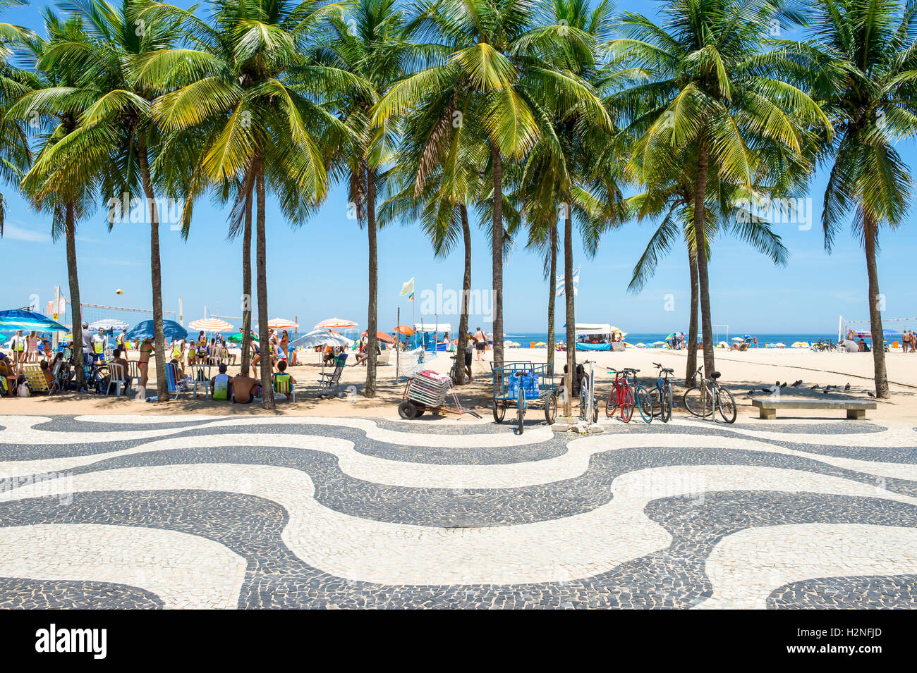 Iconic curving sidewalk tile pattern with palm trees at Copacabana ...