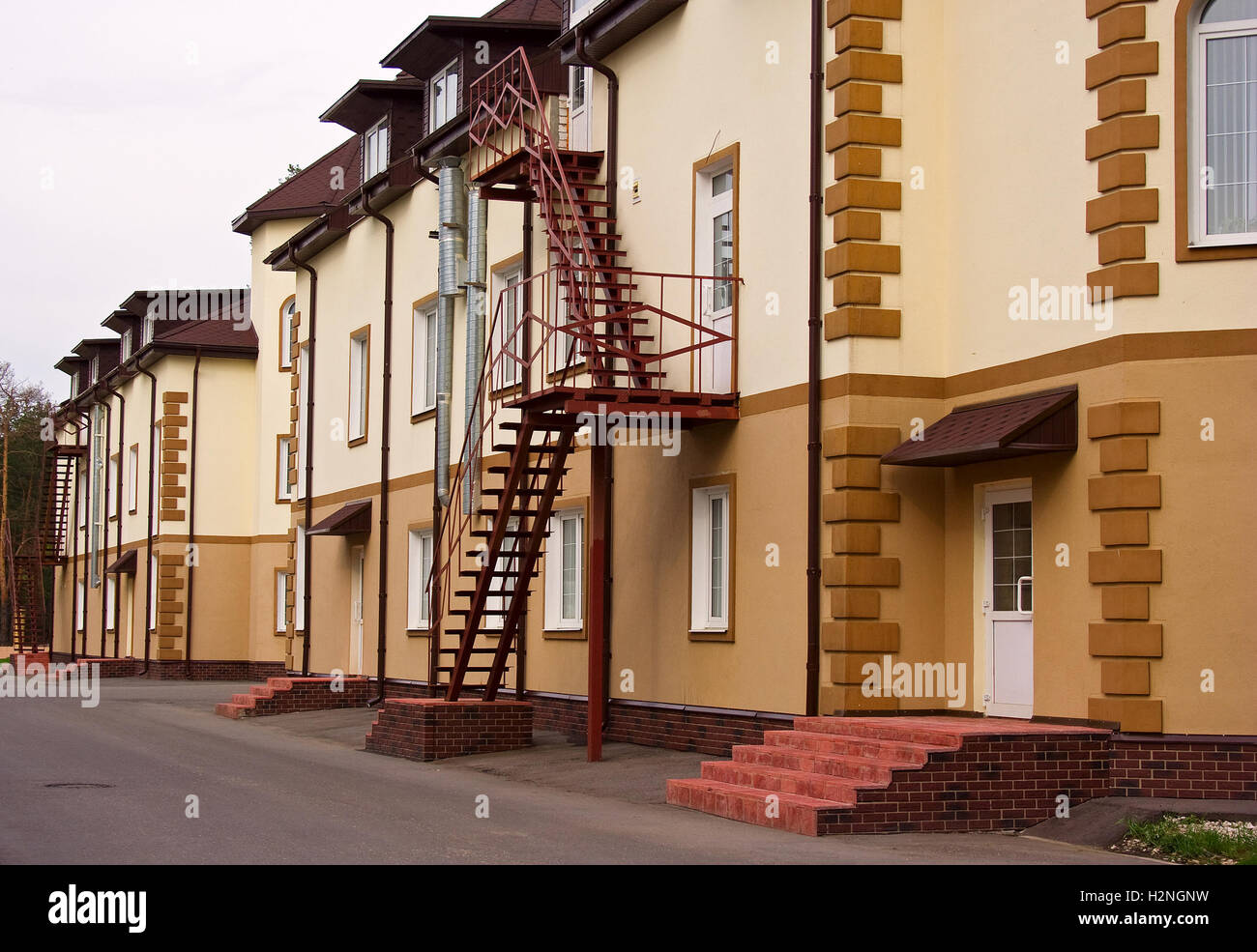 New suburban houses / buildings facades with yellow walls, entrance ...