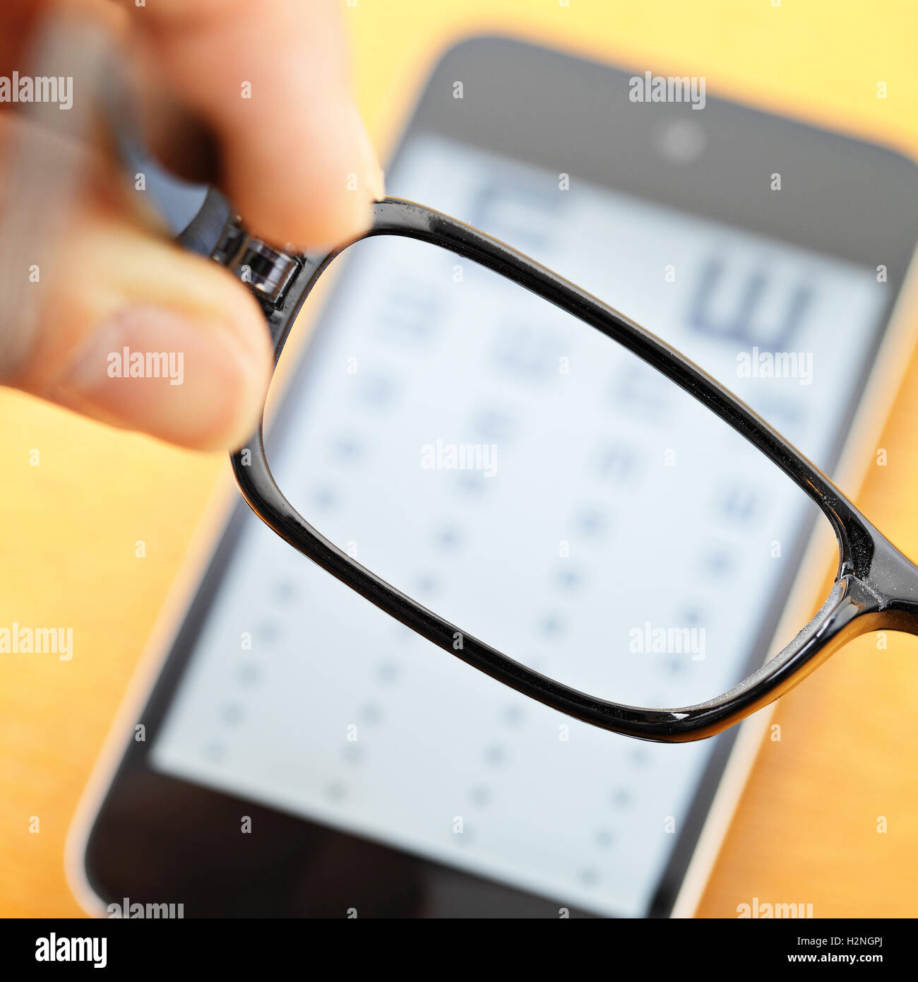 Eyechart on mobile with eyewear Stock Photo - Alamy