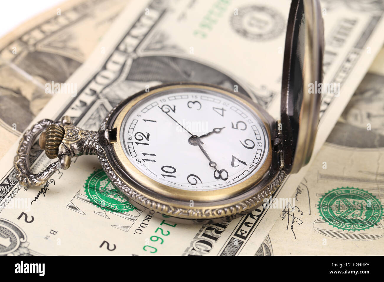 Pocket watch on money Stock Photo - Alamy