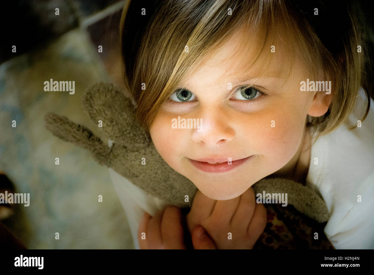 cute girl cuddling favourite toy Stock Photo - Alamy