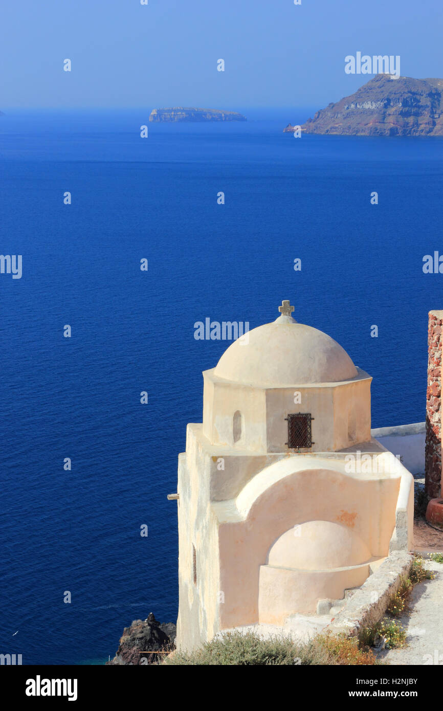 Traditional Greek white church arch with cross and bells in village Oia ...