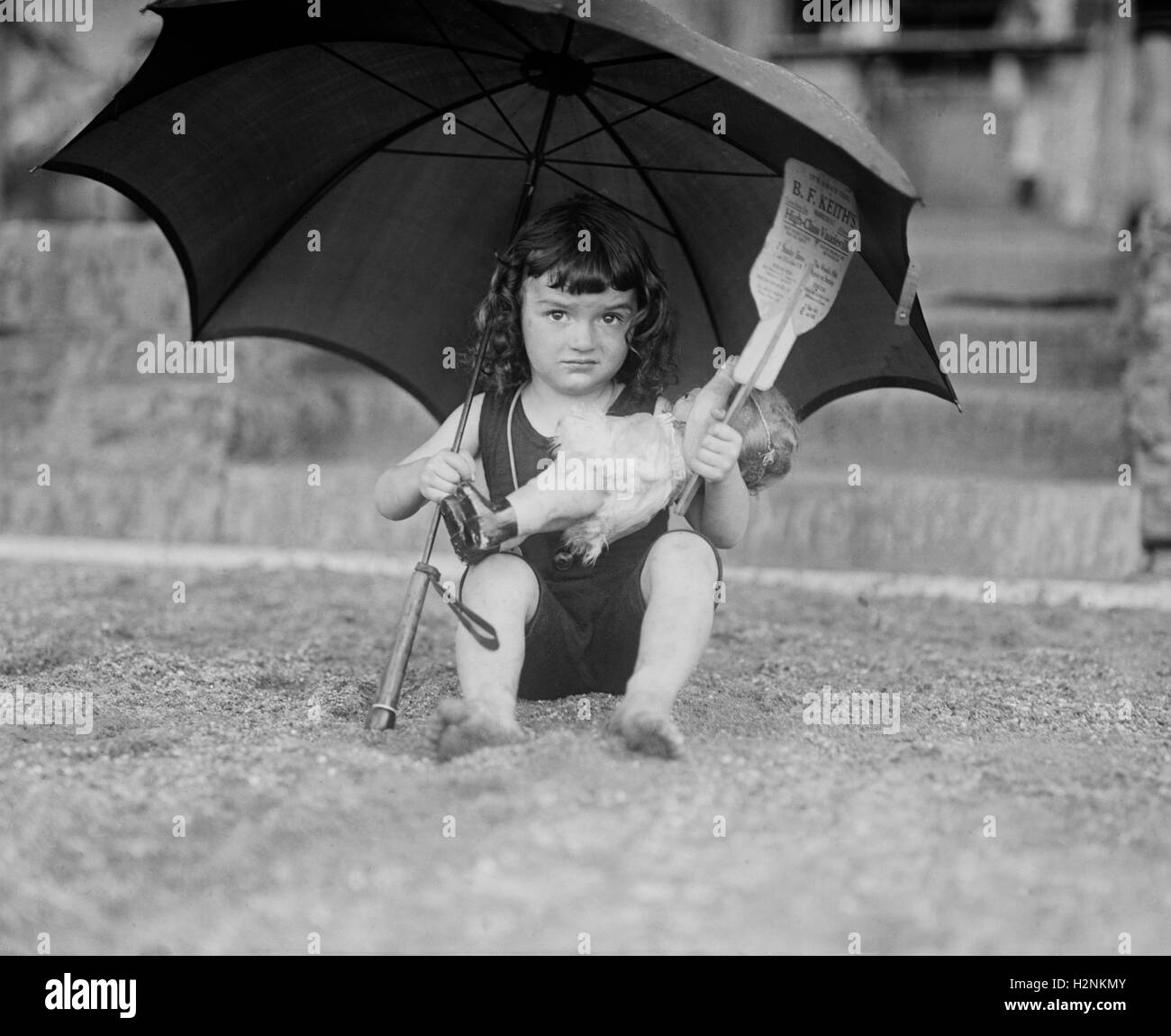 Young Girl in Bathing Suit Holding Doll and Sun Umbrella, National ...