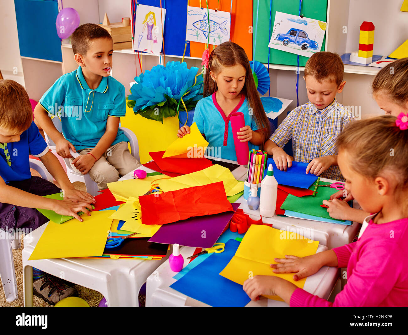 Children are making something out of colored paper Stock Photo - Alamy