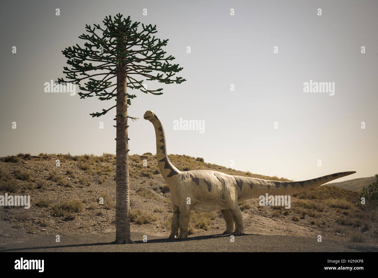 Statue of a sauropod eating the branches of Araucaria in the village of ...