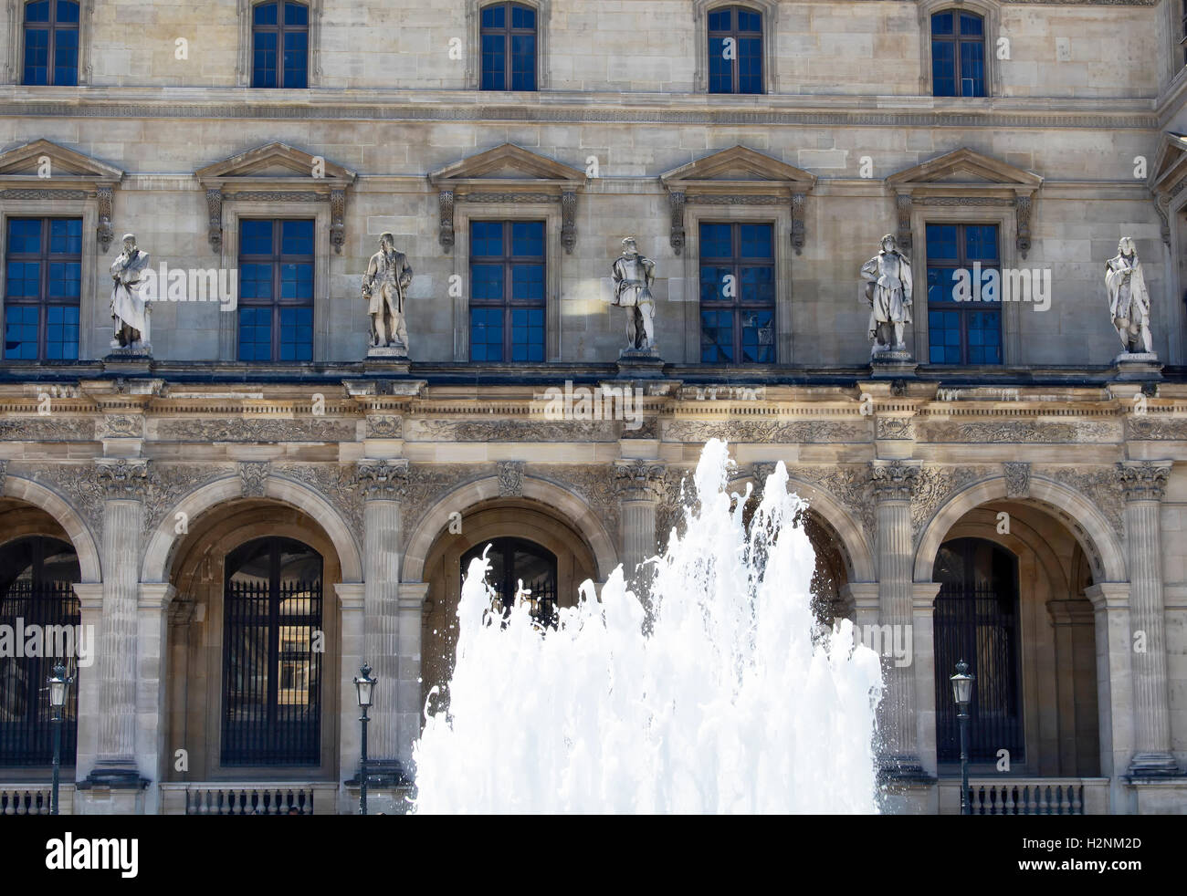 Water fountain by famous glass pyramid at the courtyard of Louvre ...