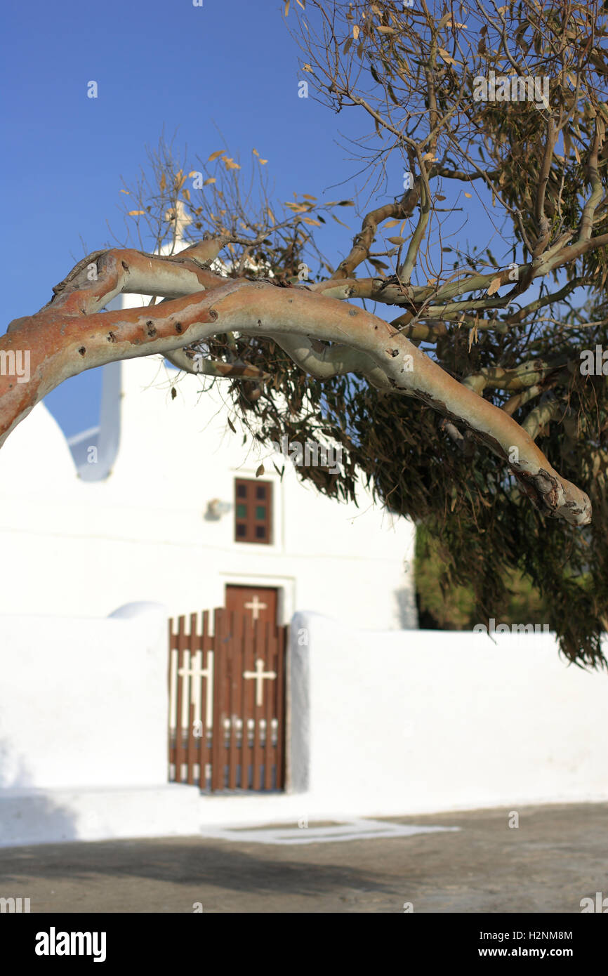 Traditional Greek white church arch with cross and bells in village Oia ...