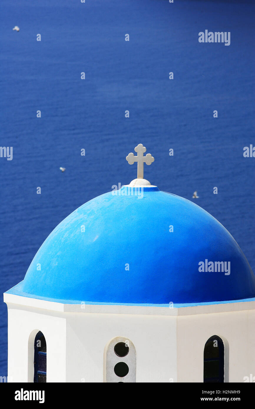 Traditional Greek white church arch with cross and bells in village Oia ...
