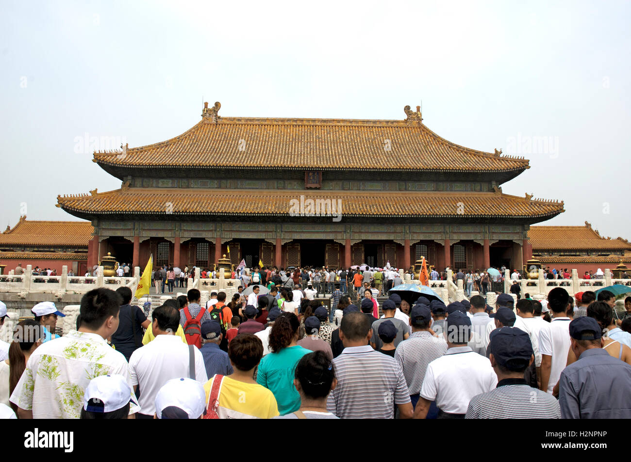 Chinese tourists face the crowds and flock through the Forbidden City ...