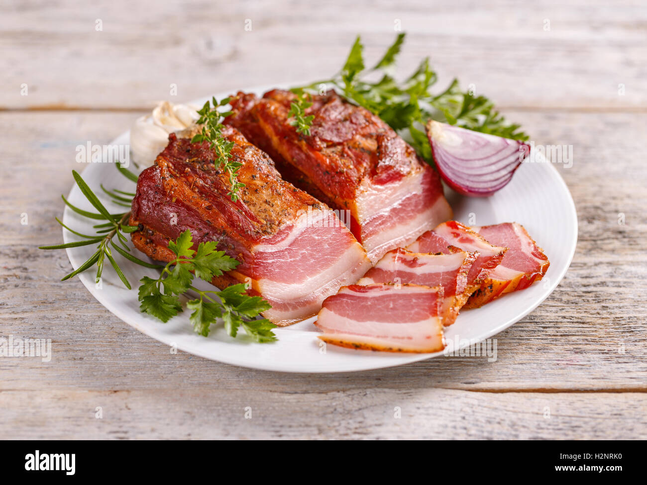 Smoked bacon on white plate Stock Photo - Alamy