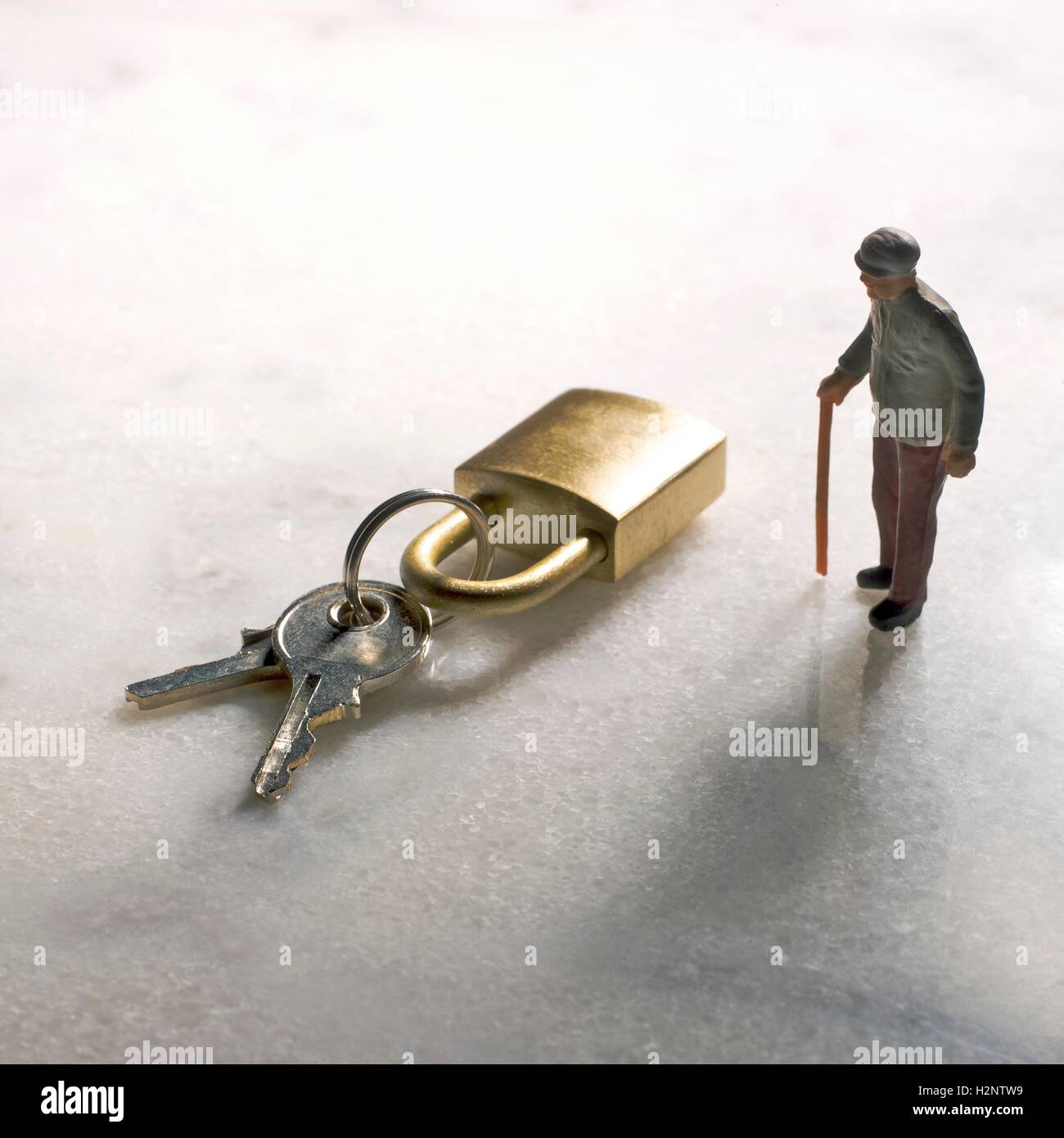 Senior citizen, figurine, and keys, symbolic image for inheritance ...