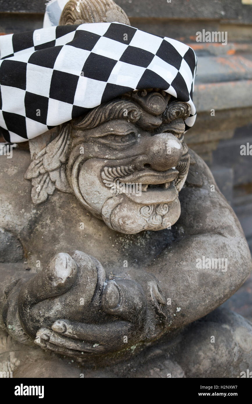 Indonesia, Bali, Sidemen, figure outside, Hindu temple wrapped in Saput ...
