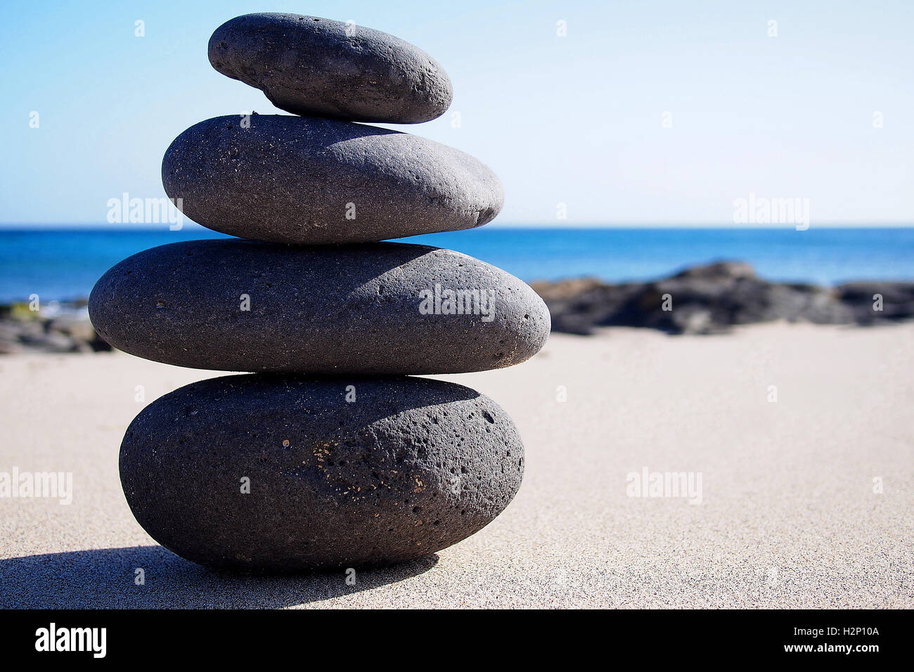 Stack of zen stones on the sand Stock Photo - Alamy