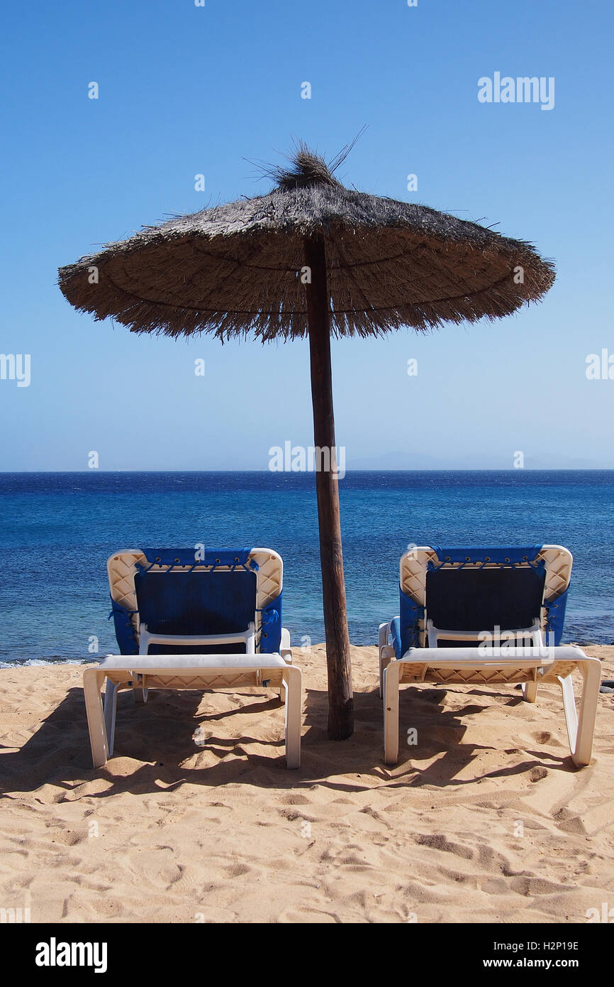 Beach chairs on perfect sand beach Stock Photo - Alamy