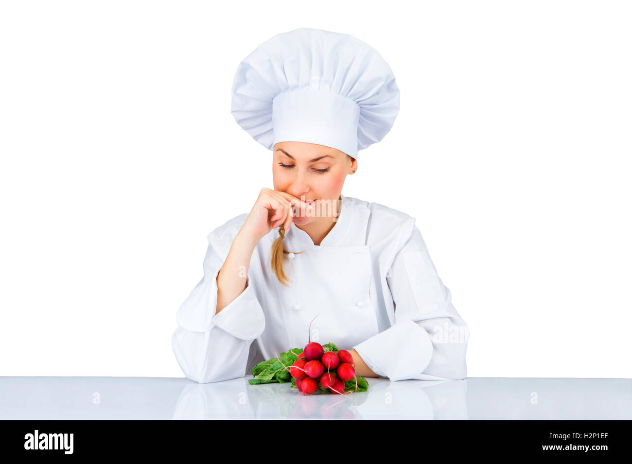 Chef woman. Isolated over white background by the table with vegetable ...
