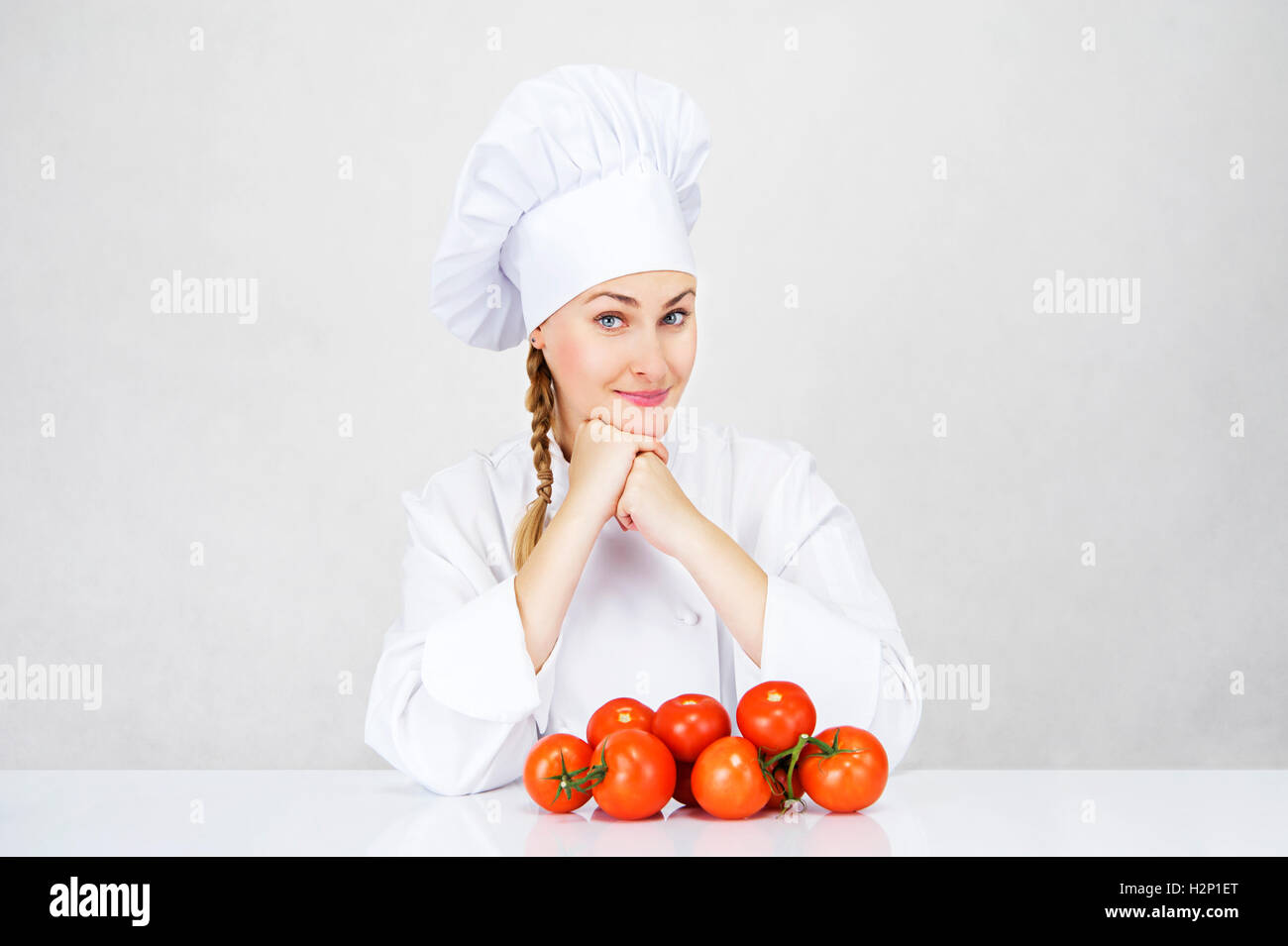 young woman chef showing ingredients for italian food on white Stock ...