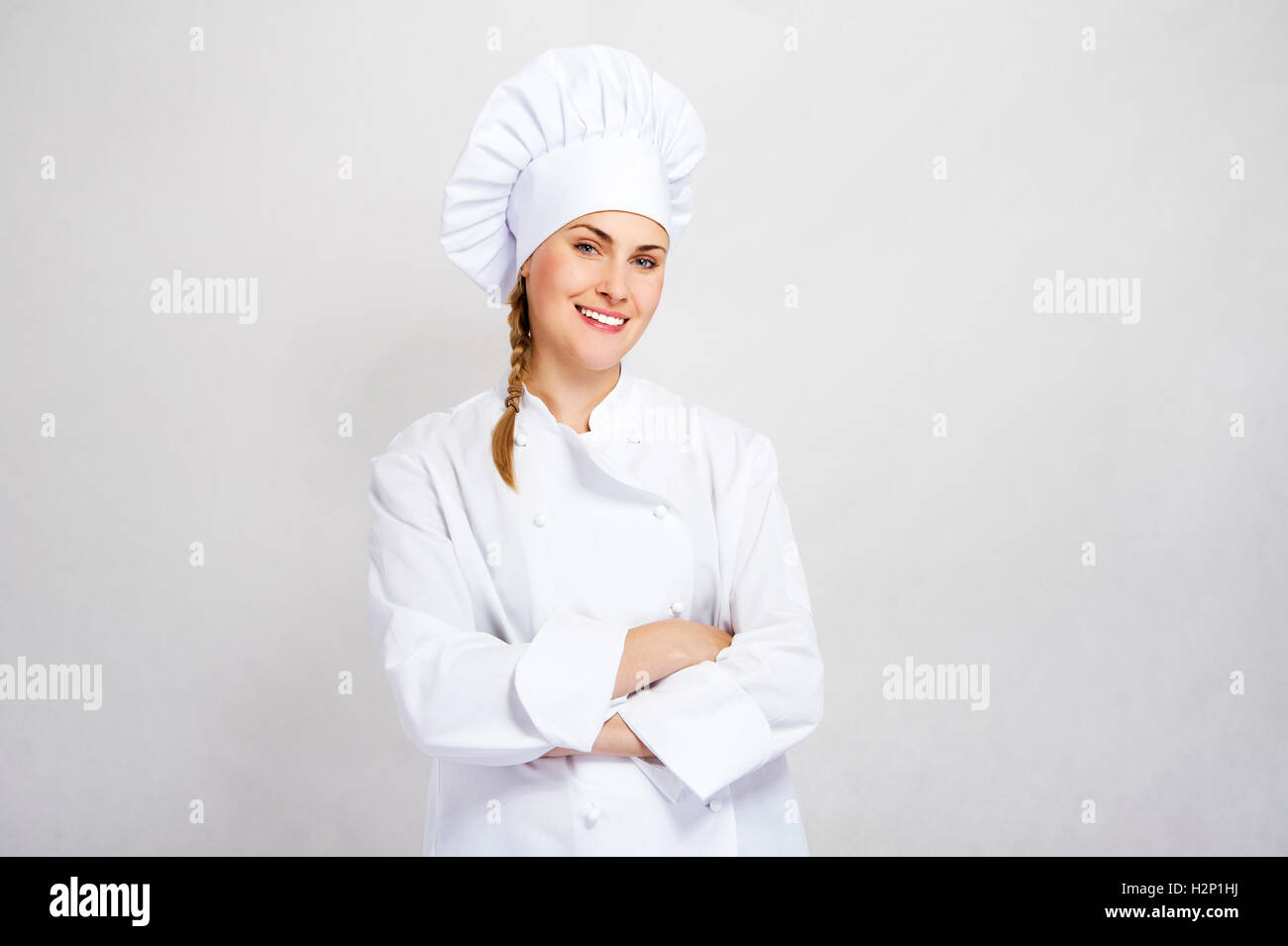 A young, female chef in a traditional hat and coat Stock Photo - Alamy