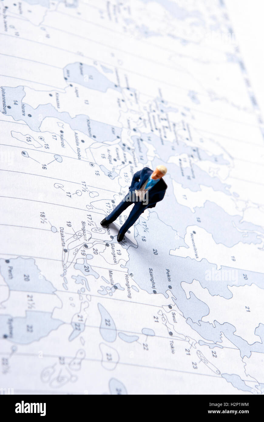 miniature man on map Stock Photo - Alamy