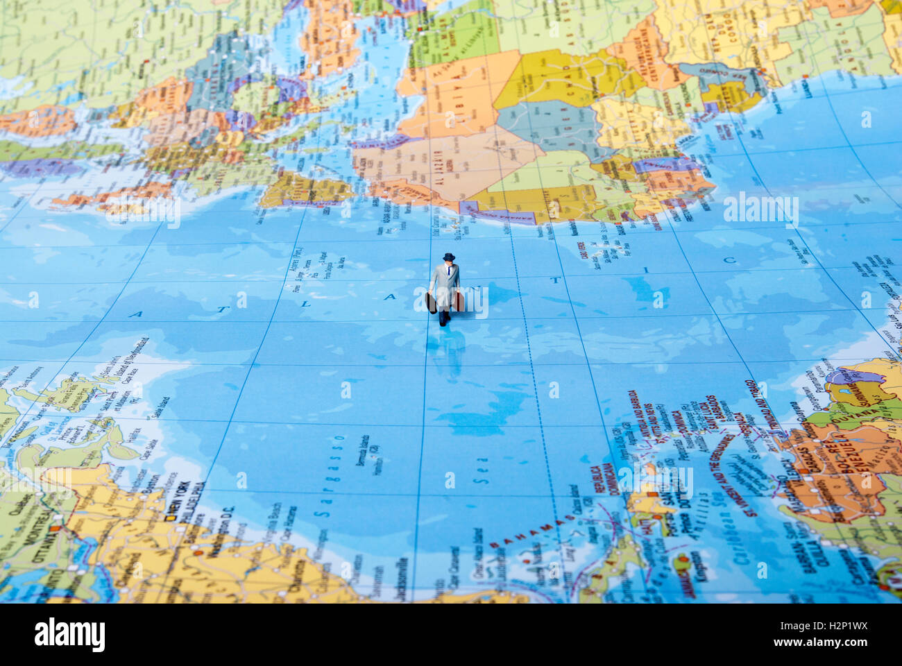 miniature man on world map Stock Photo - Alamy