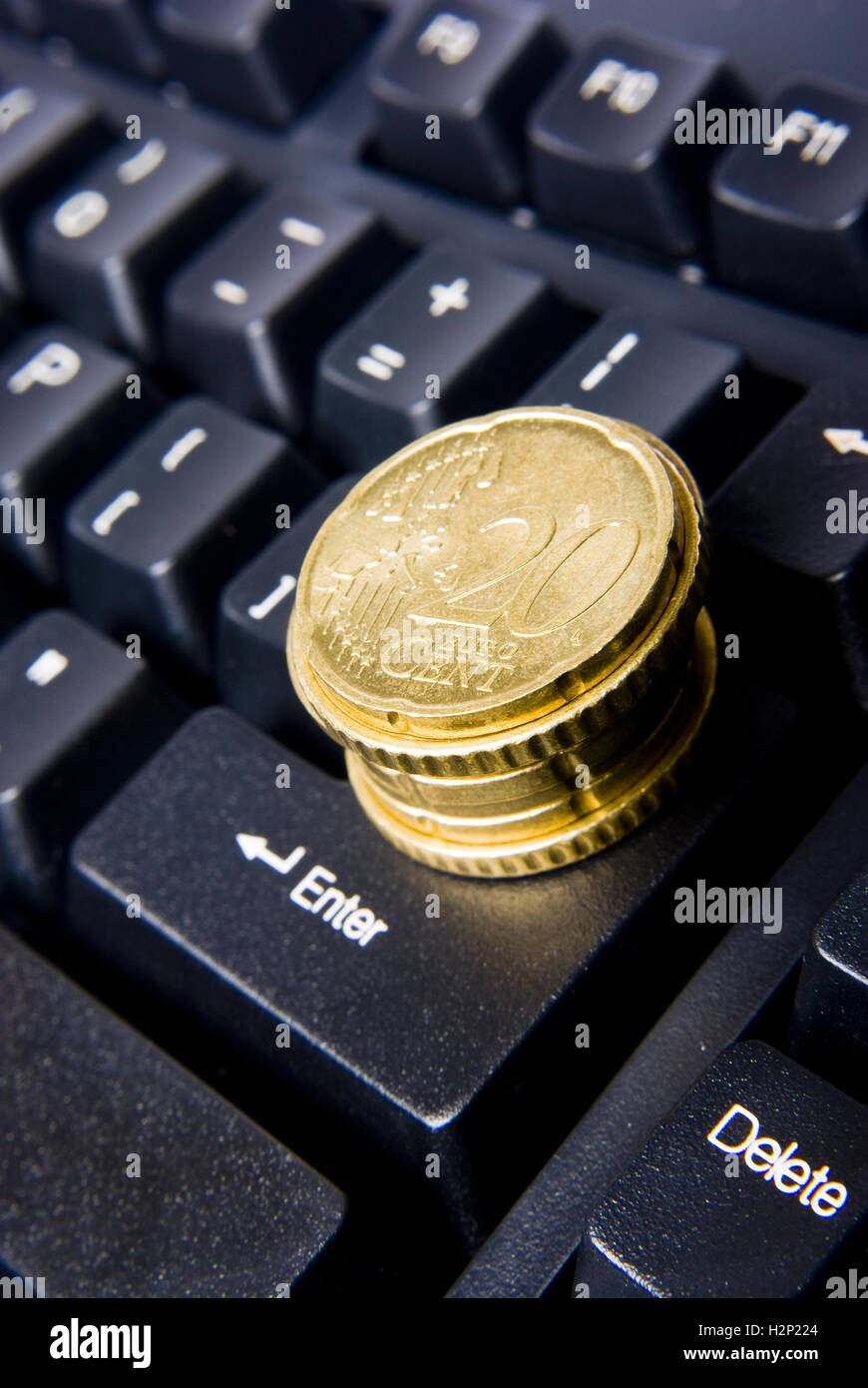 keyboard with pile of coins Stock Photo - Alamy