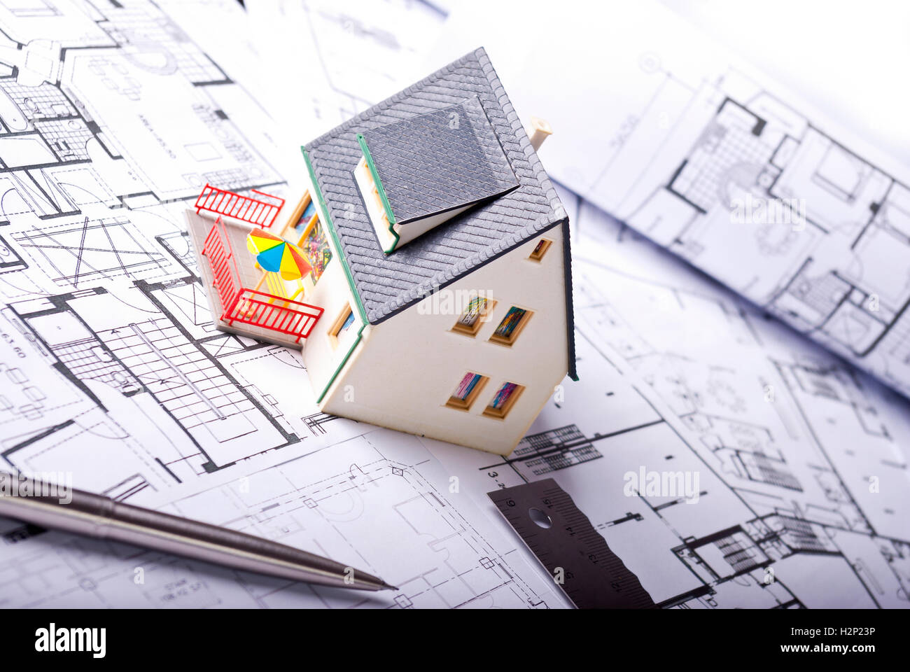 miniature house on plans document Stock Photo - Alamy