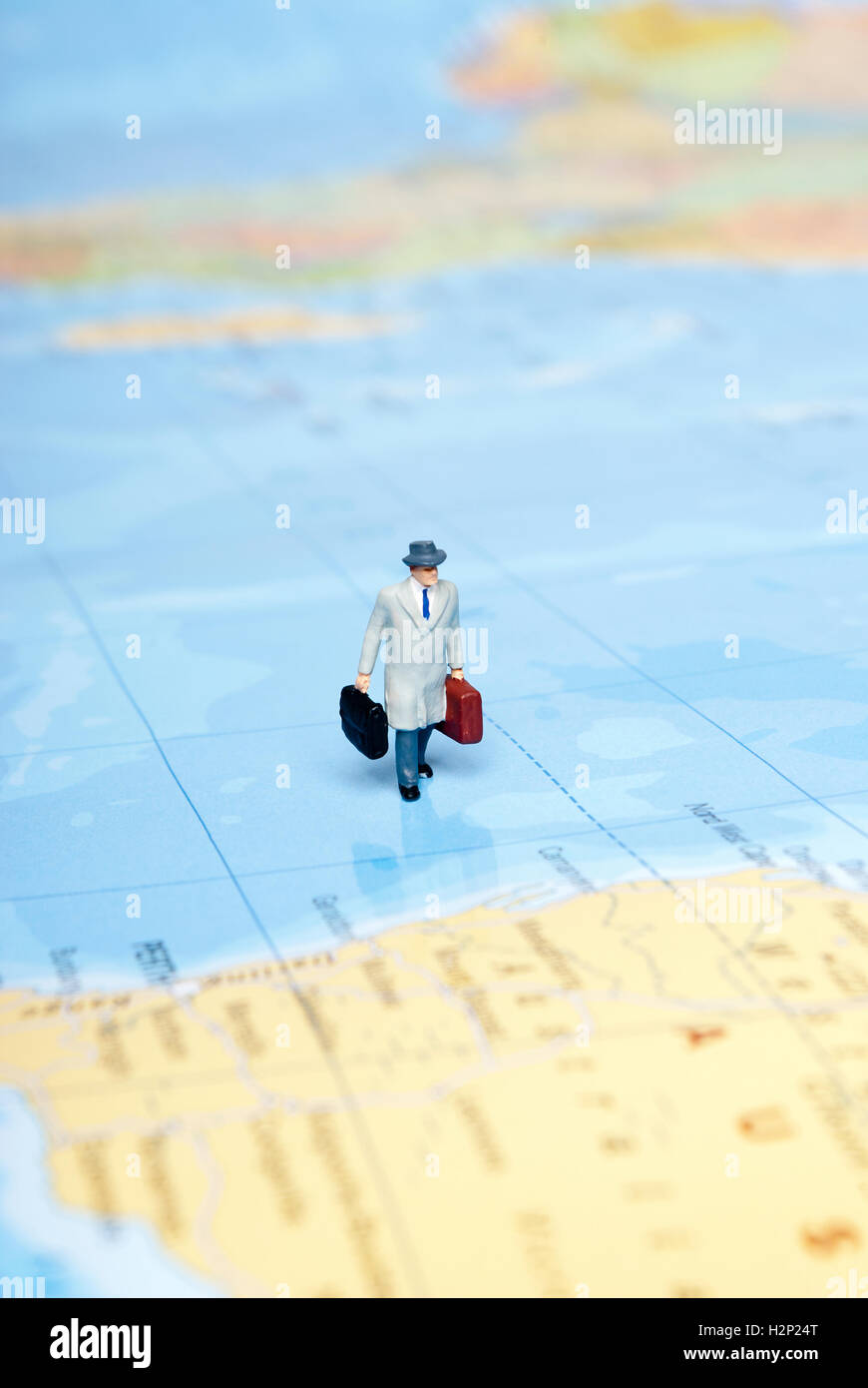 miniature man on world map Stock Photo - Alamy