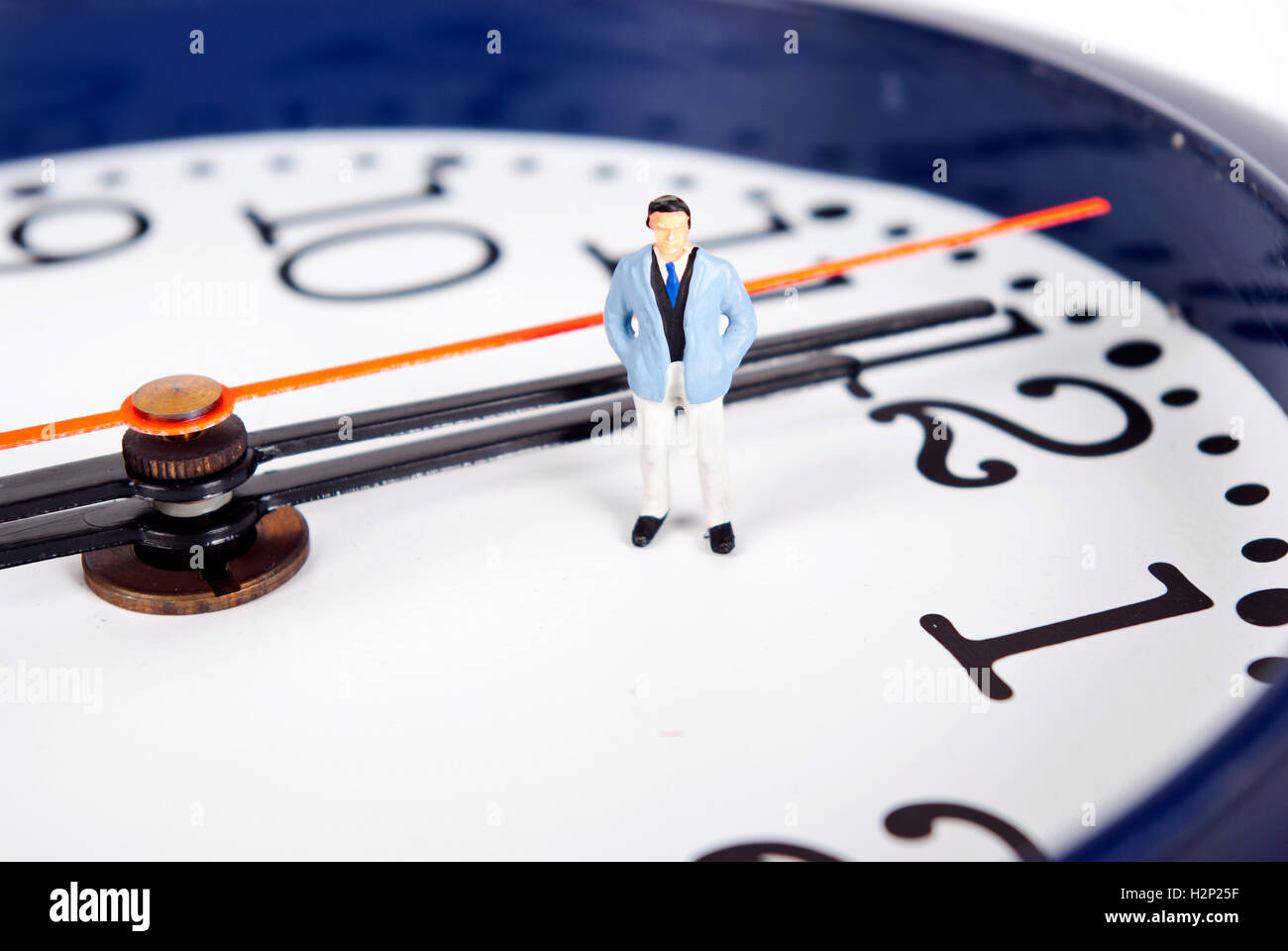 miniature man on the clock Stock Photo - Alamy