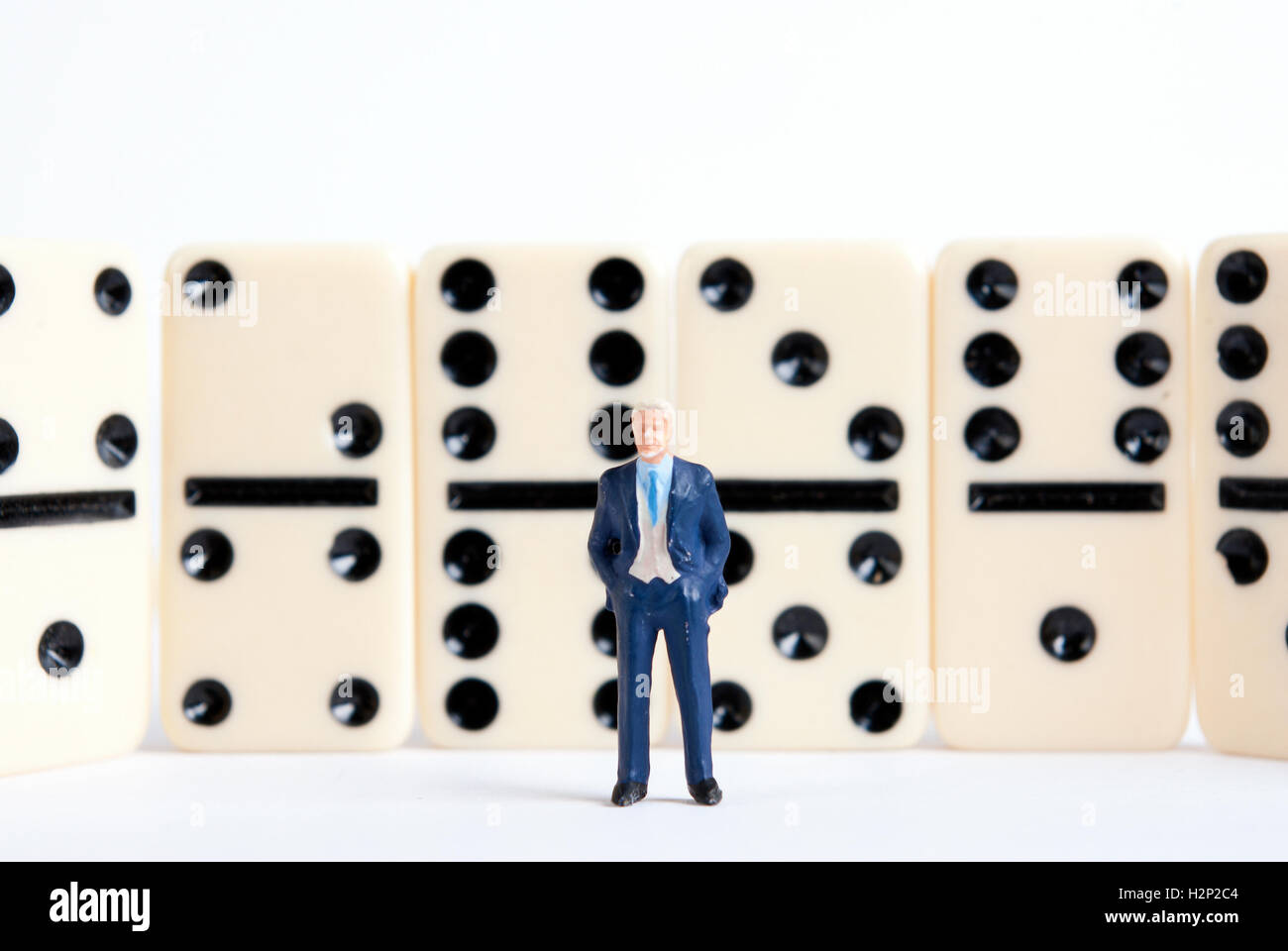 one man on domino cubes Stock Photo - Alamy