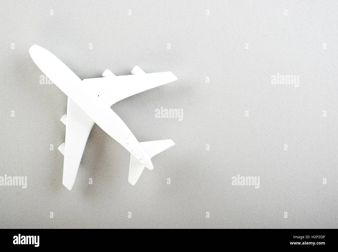 white airplane on grey background Stock Photo - Alamy