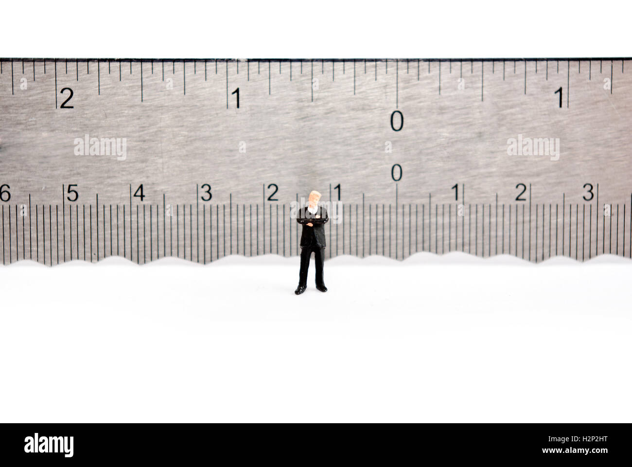 miniature man with ruller Stock Photo - Alamy