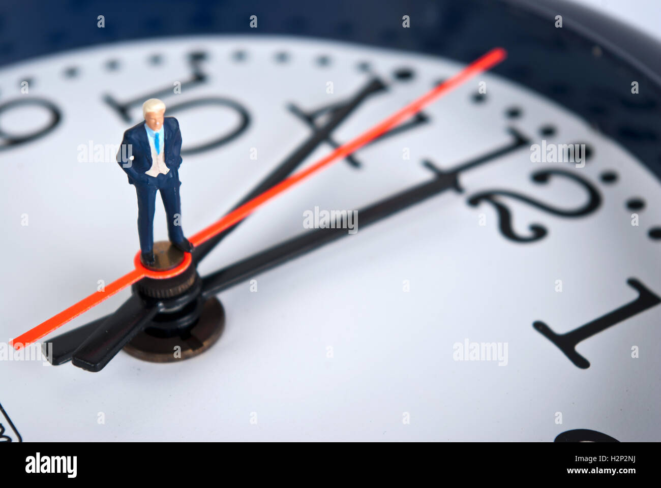 miniature man on the clock Stock Photo - Alamy