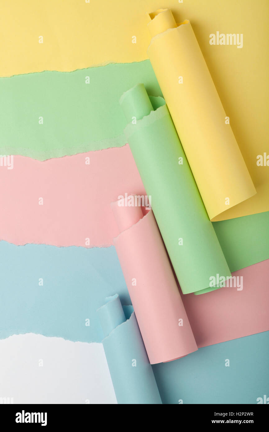 Tear in colored papers revealing white background underneath Stock ...
