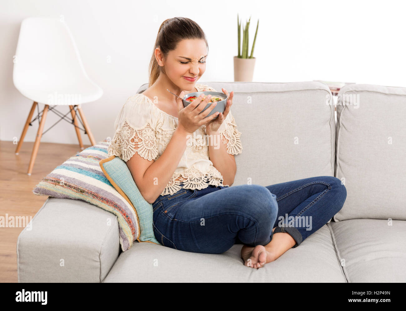 Beautiful woman at home smelling her bowl full of healthy food Stock ...