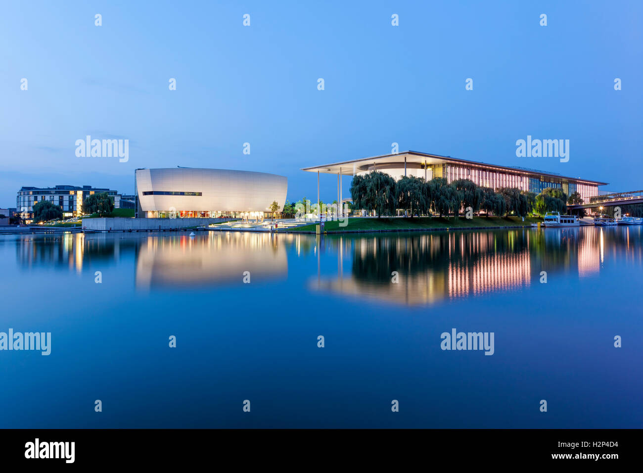 Contemporary buildings at the Volkswagen Autostadt illuminated at night ...