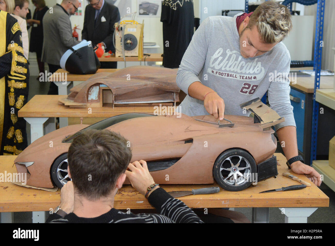 A model car is worked on with manual tools in the design process by ...