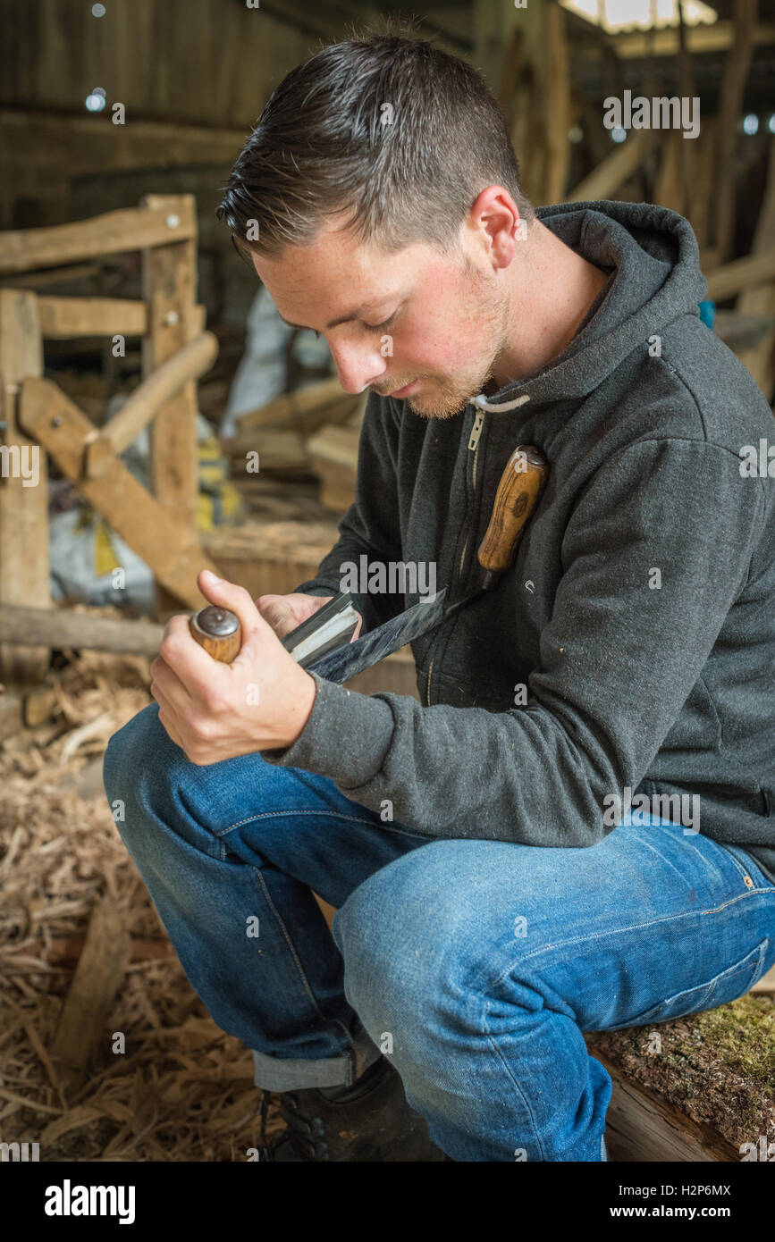 Craftsman sharpening a tool Stock Photo - Alamy